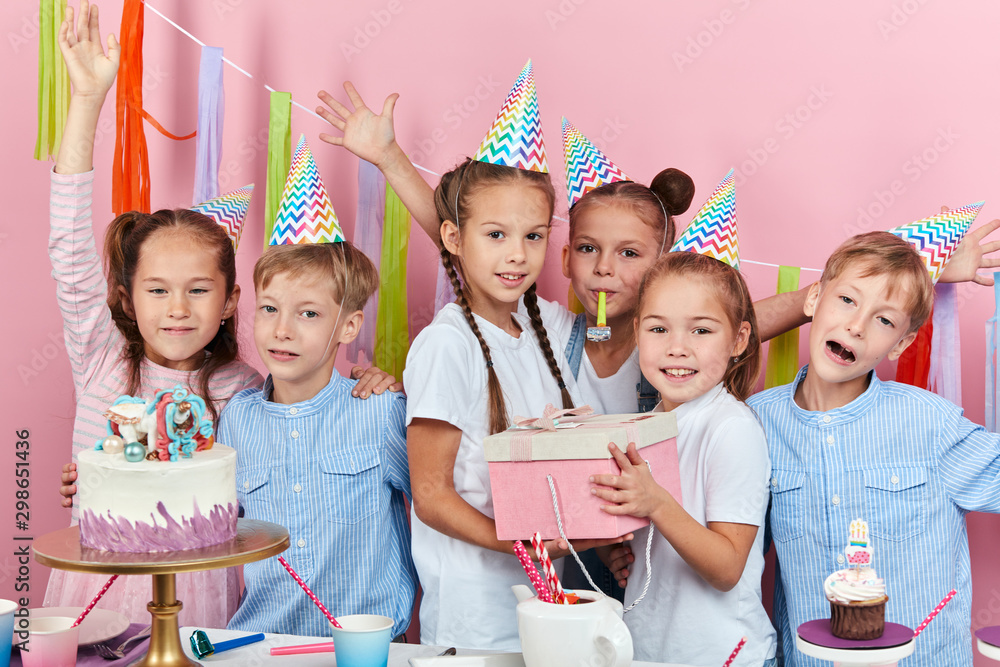 good looking little boys and girls throwing a party, close up side view ...