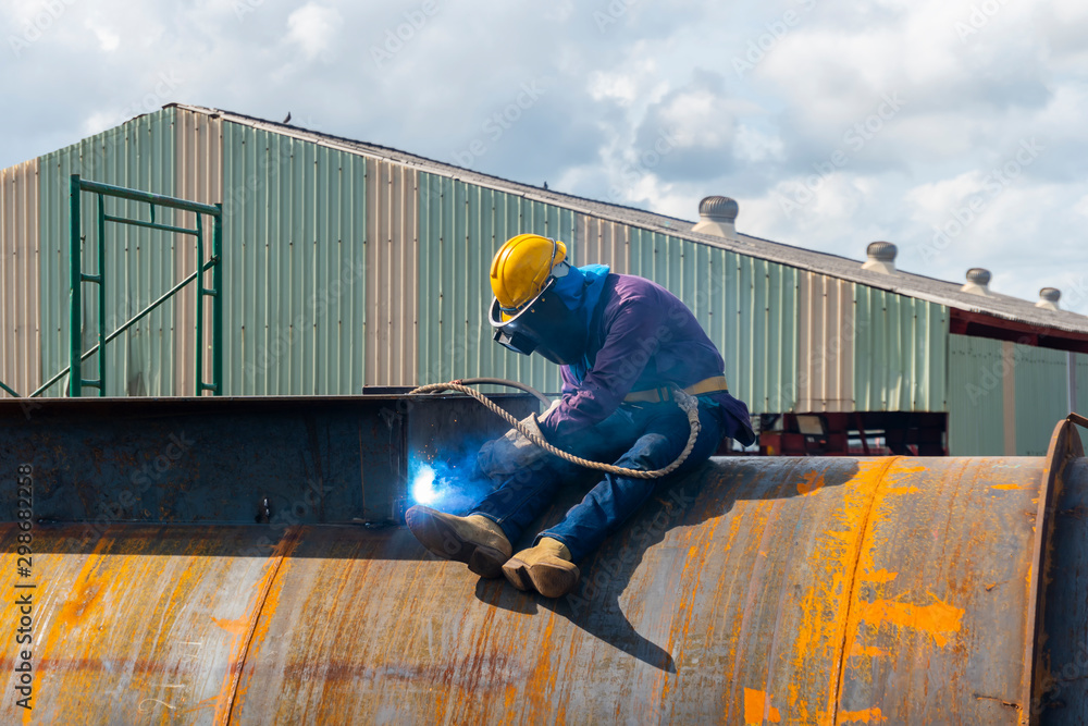 The welder is welding a steel structure with the process Flux Cored Arc ...