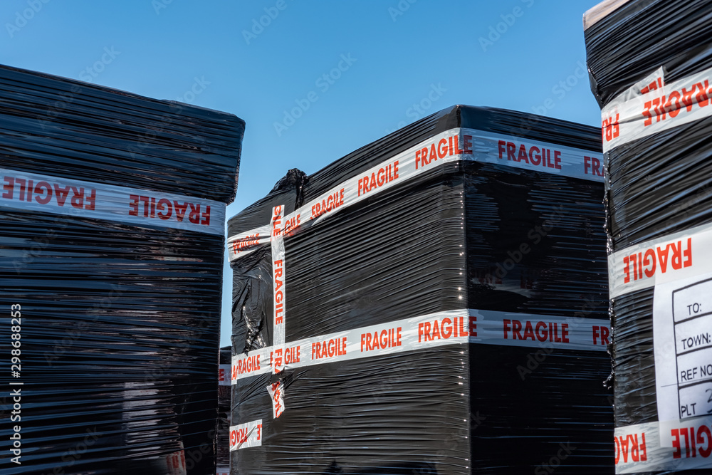 Shallow focus of tall heavy goods seen outside a dispatch warehouse ...