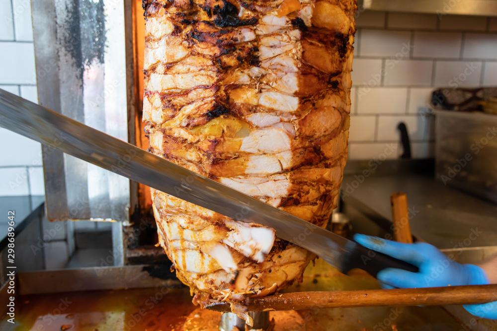 Chef cutting with doner knife Traditional Turkish Doner Kebab meat ...
