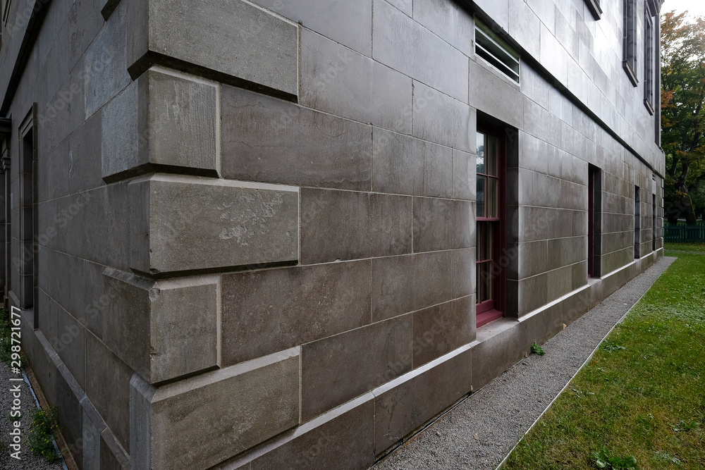 he corner view of a large stone government courthouse. The old marble ...