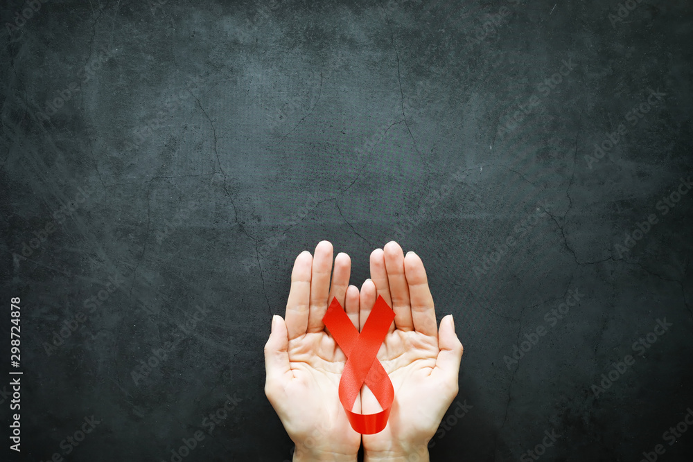 Symbol of human immunodeficiency virus disease. Red ribbon. A helping ...