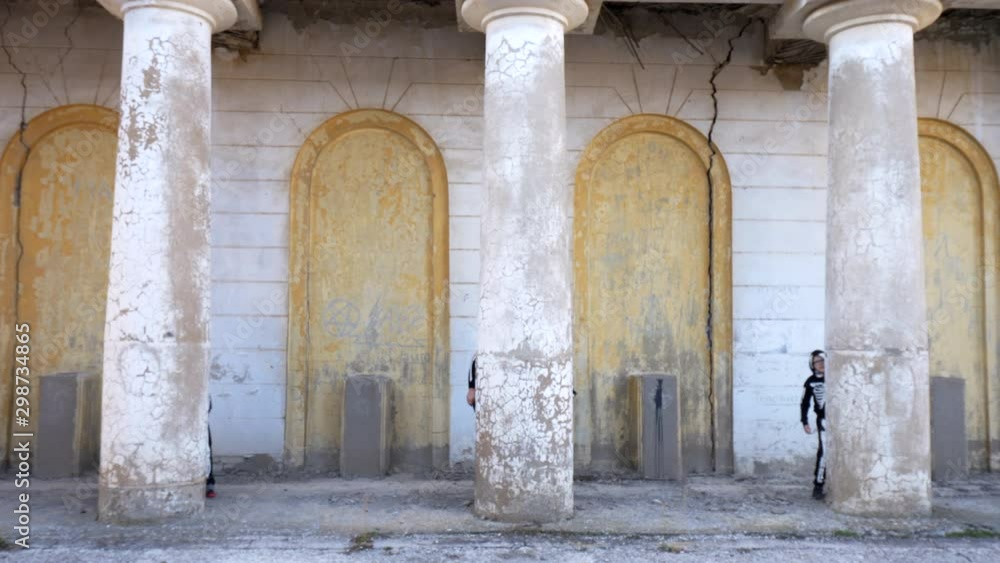 Children and their mother in carnival costumes celebrate Halloween in ...