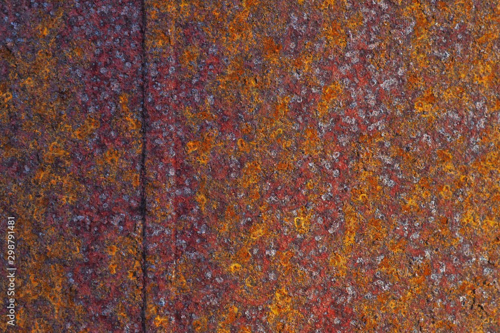 Rusty iron surface with a vertical seam. Dark background, high ...