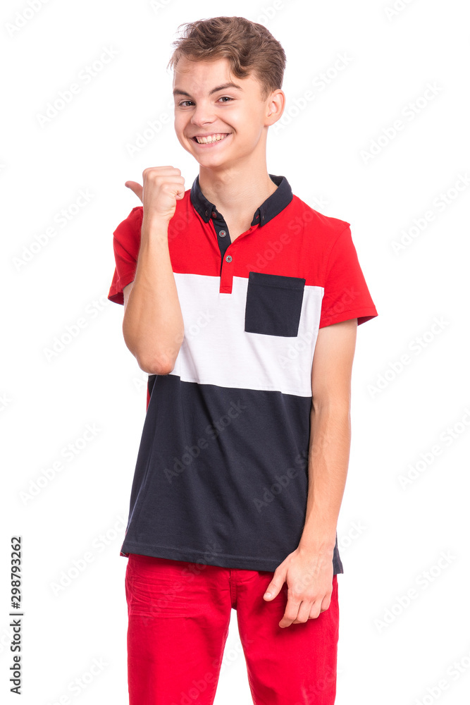 Portrait of teen boy pointing to back behind with hand and thumb up ...