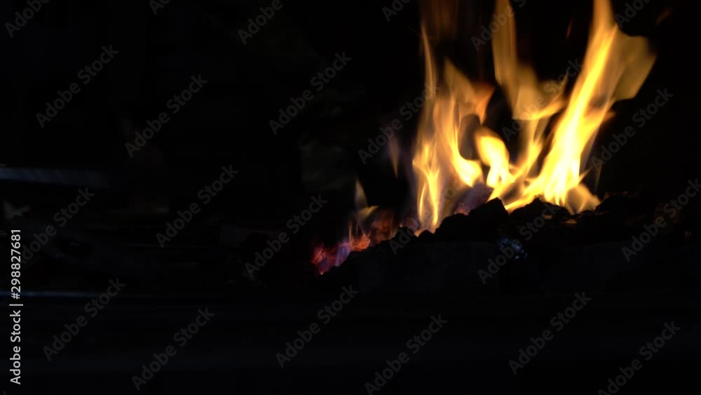 We can see the blacksmith working hard with an object in the fire. The ...