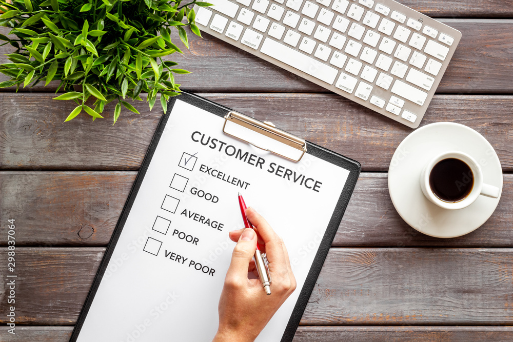 Service quality assessment. Hand fill customer service form on dark ...