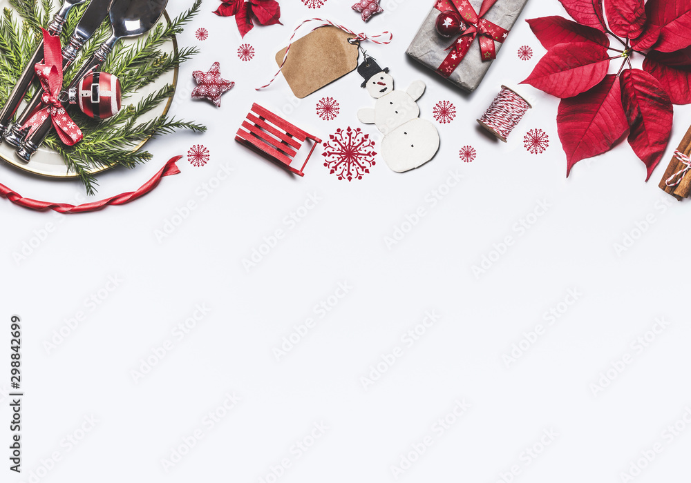 Christmas border made with poinsettia, gift box, festive table setting ...