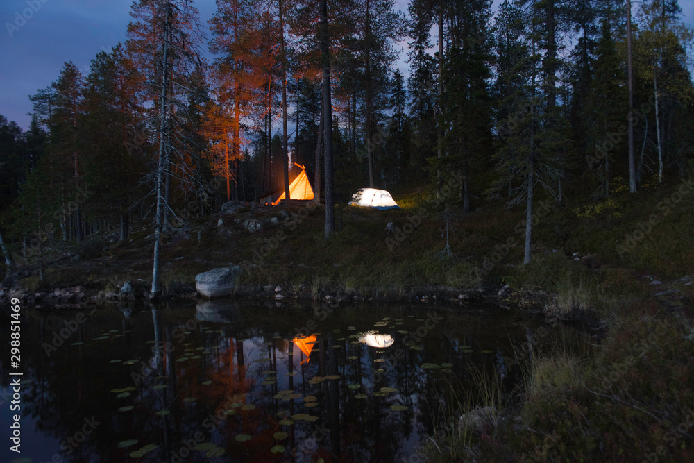 Illuminated tent and shelter in moonlight and lake reflection Stock ...