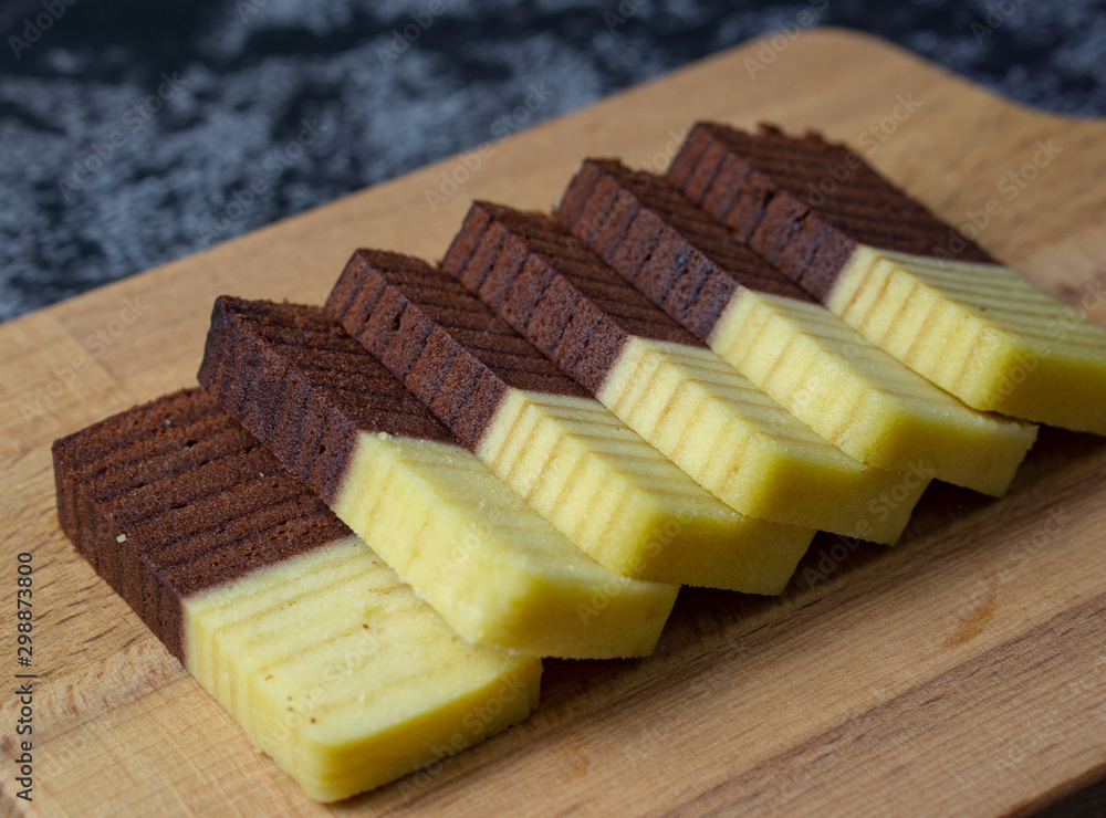 Malaysian dish "Kek Lapis Sarawak" or Sarawak layered cake over wooden ...