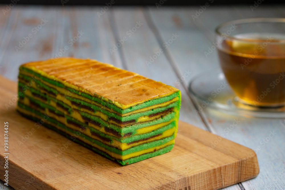 Malaysian dish "Kek Lapis Sarawak" or Sarawak layered cake over wooden ...