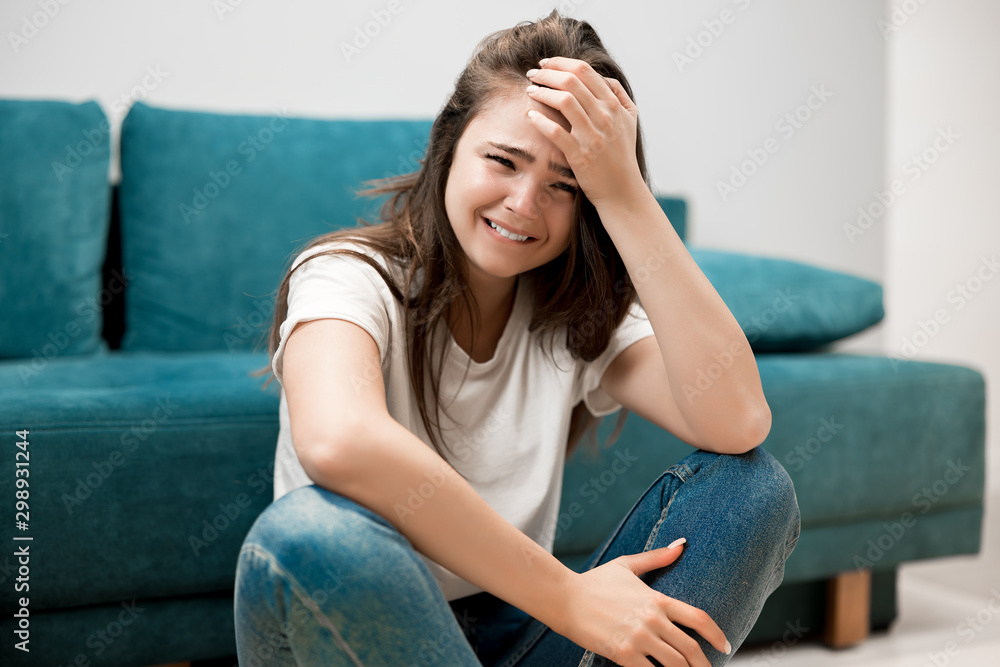 beautiful young woman crying feeling very depressed sitting on floor ...