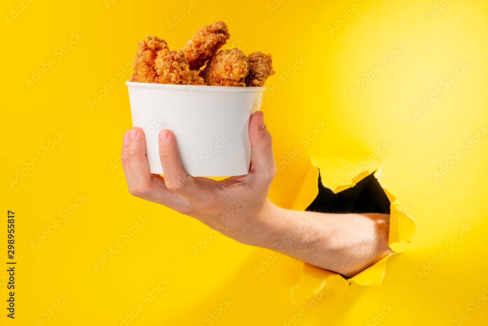 Hand giving chicken nuggets Stock Photo | Adobe Stock