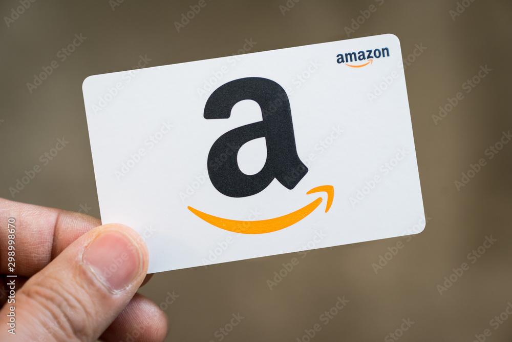 Hand hold an Amazon gift card isolated Stock Photo | Adobe Stock
