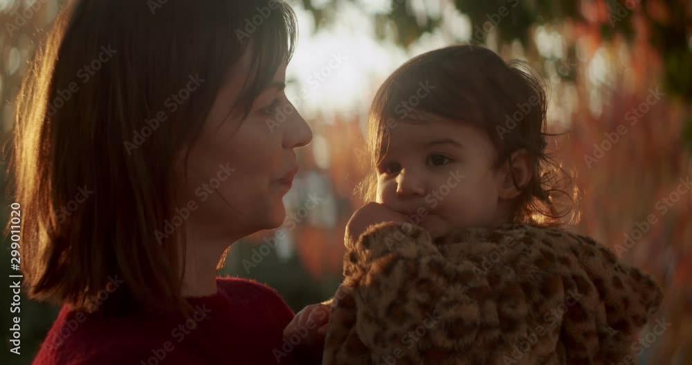 Mother and baby daughter exploring the outdoors during the fall. 4K ...
