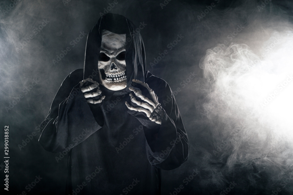 Scary looking grim reaper ghost coming out of the foggy mist. The ...