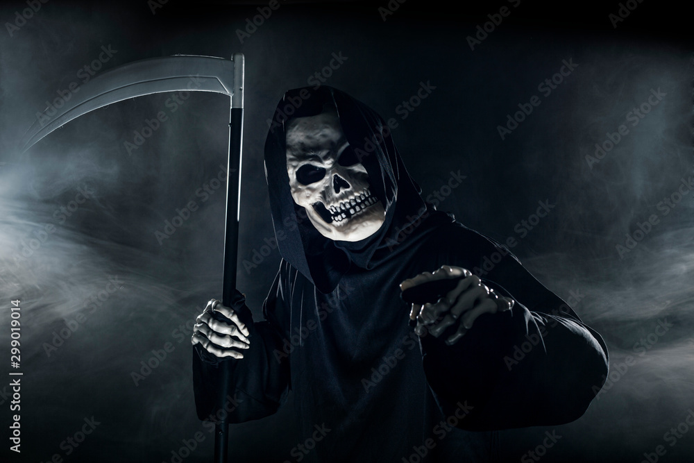 Scary looking grim reaper ghost wielding a scythe or sickle coming out ...
