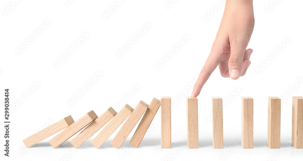 Hand stopping the Domino effect stopped by unique Stock Photo | Adobe Stock