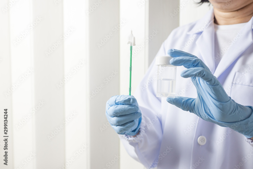 Doctor hand holding liquid base cytology set on blue background ...