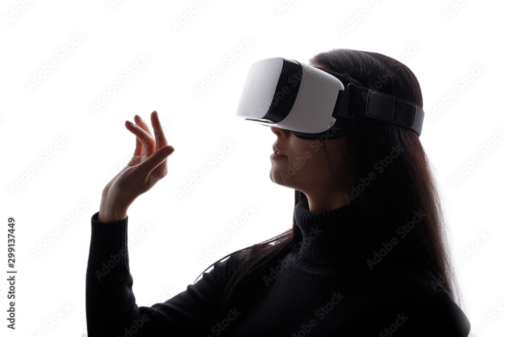 Beautiful woman using VR helmet while touching air on white background ...