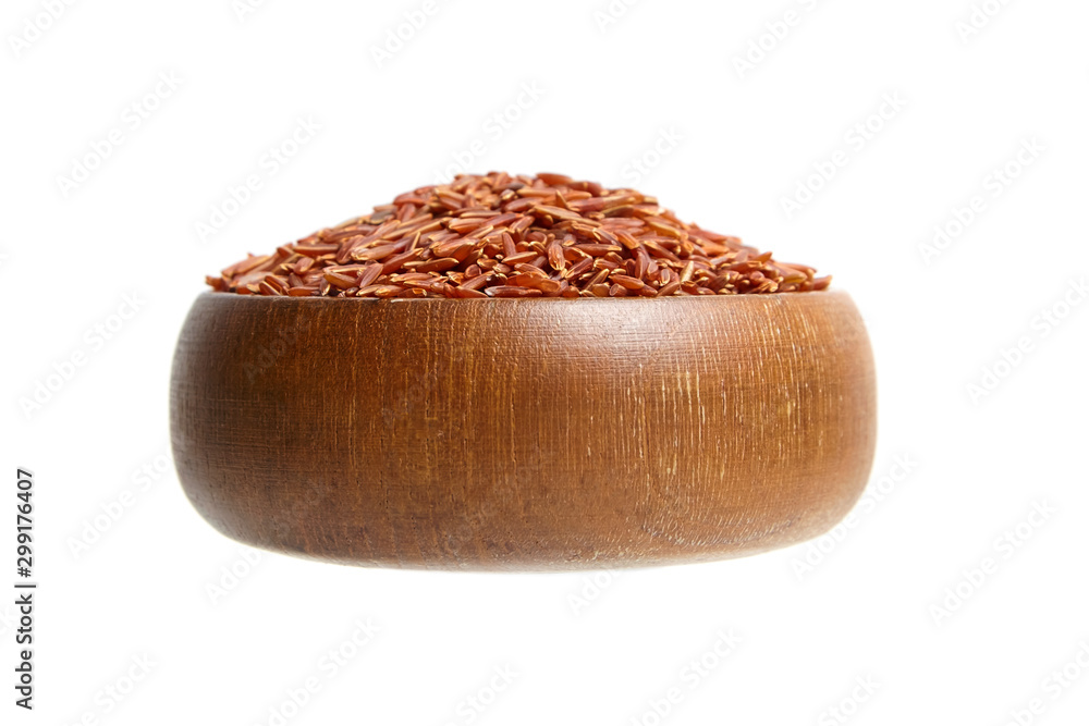Red rice in a brown wooden bowl isolated on white background. Dry ...