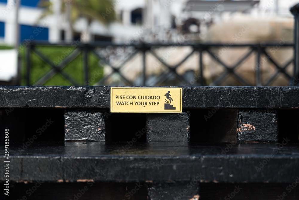 Bilingual Sign on Steps Painted Black in English and Spanish - Pise Con ...