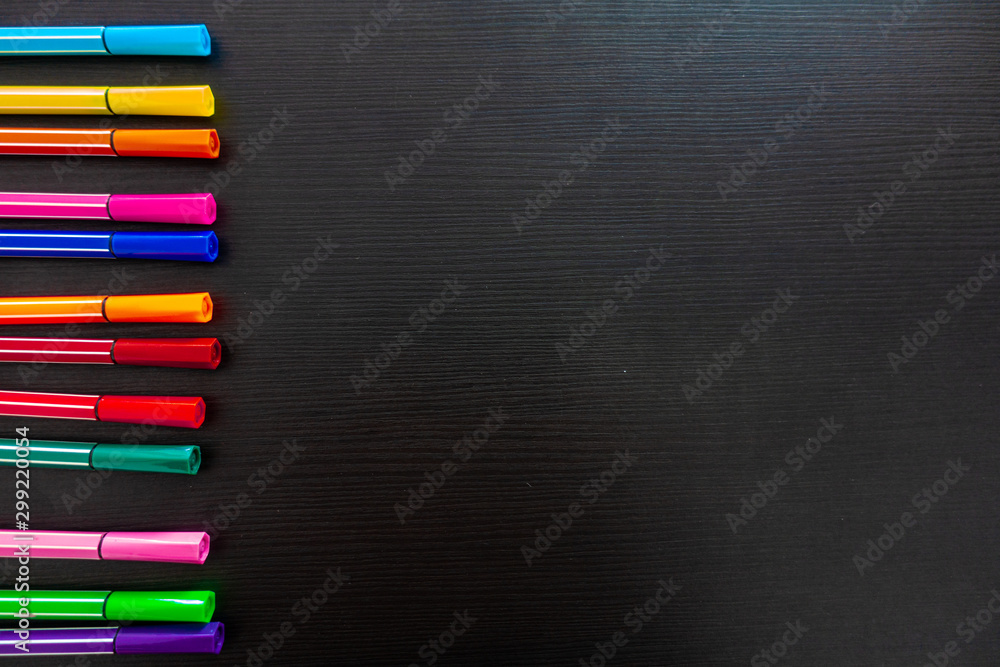 Color pen in variety color on the side on dark brown copy space ...