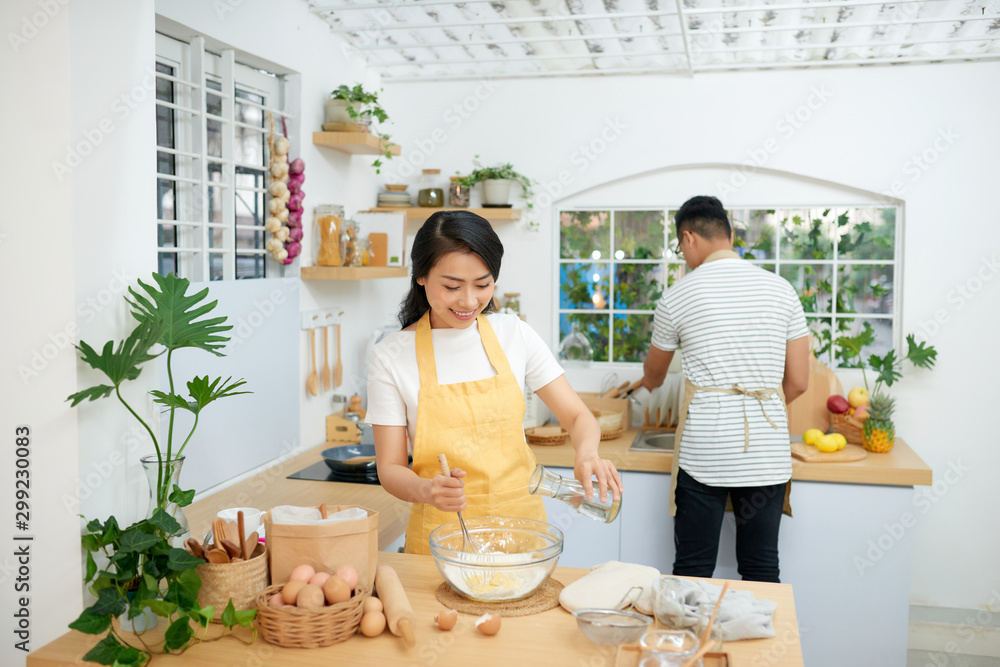 Couple cooking bakery in kitchen room, Young asian man and woman ...