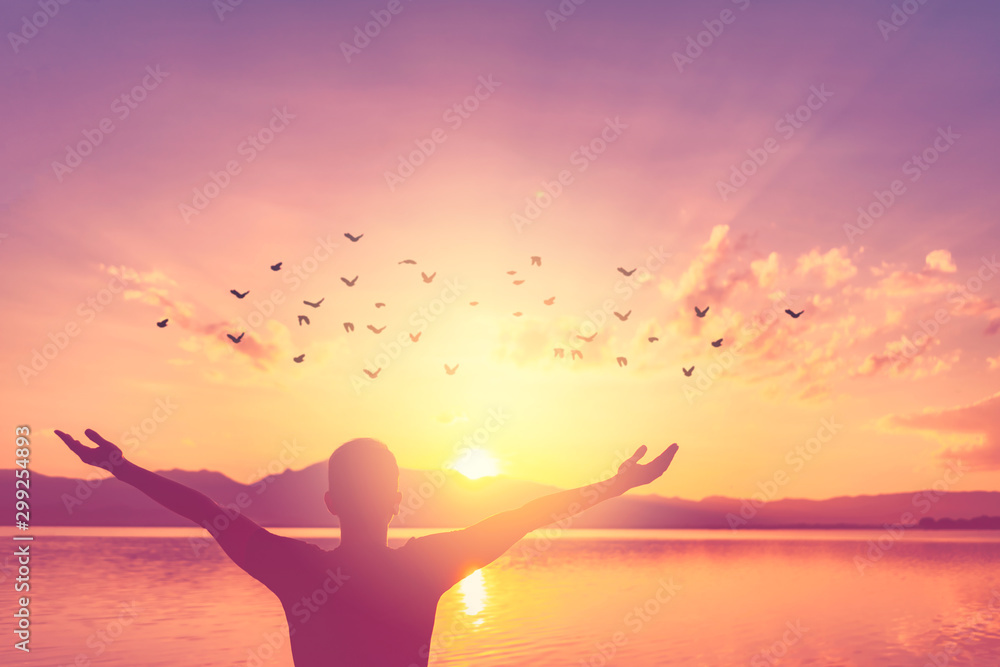 Copy space of man raise hand up on sunset sky at beach and island ...