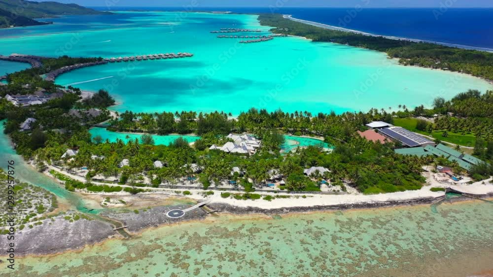 Aerial of a beautiful tropical island with helicopter landing pad in a ...