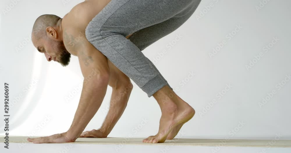 gymnast is stretching during training, sitting in static position ...