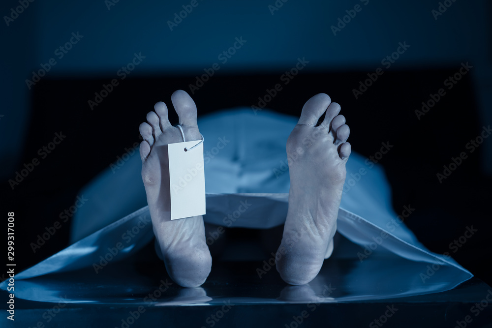 Cadaver on autopsy table at morgue, label tied to toe, close-up Stock ...