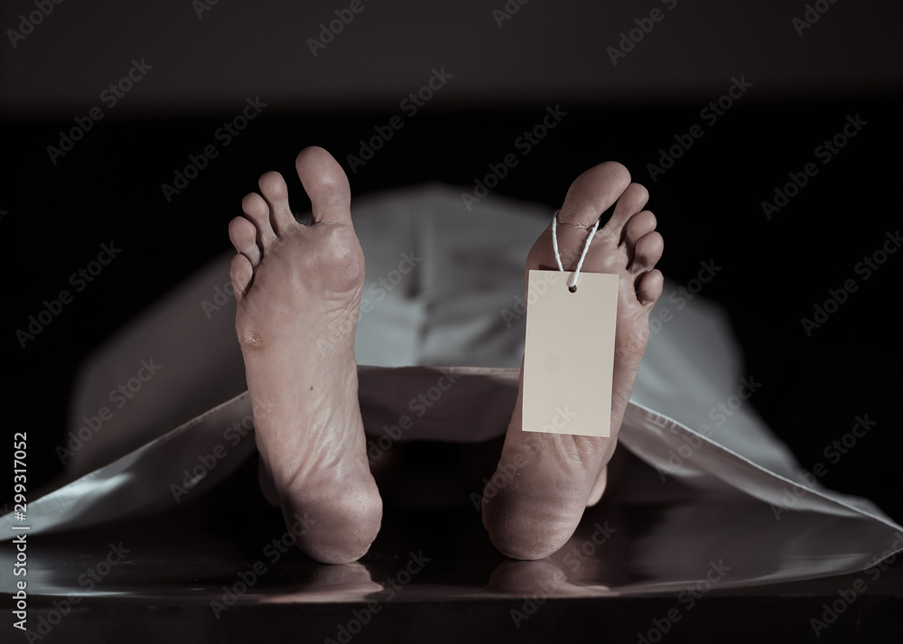 Cadaver on autopsy table at morgue, label tied to toe, close-up Stock ...