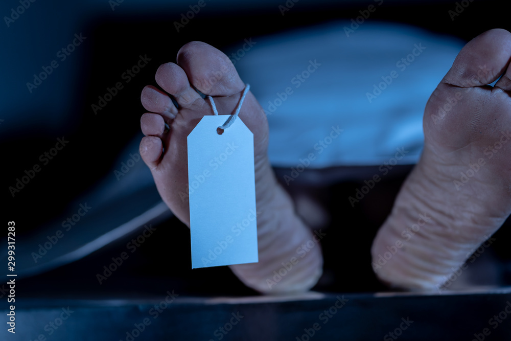 Cadaver on autopsy table at morgue, label tied to toe, close-up Stock ...