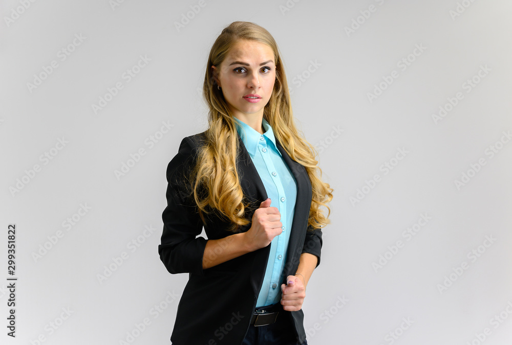 Portrait of a pretty blonde secretary girl with long curly hair in a ...