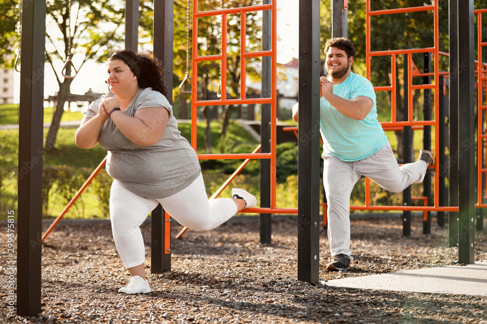 Overweight couple training together on sports ground Stock Photo ...