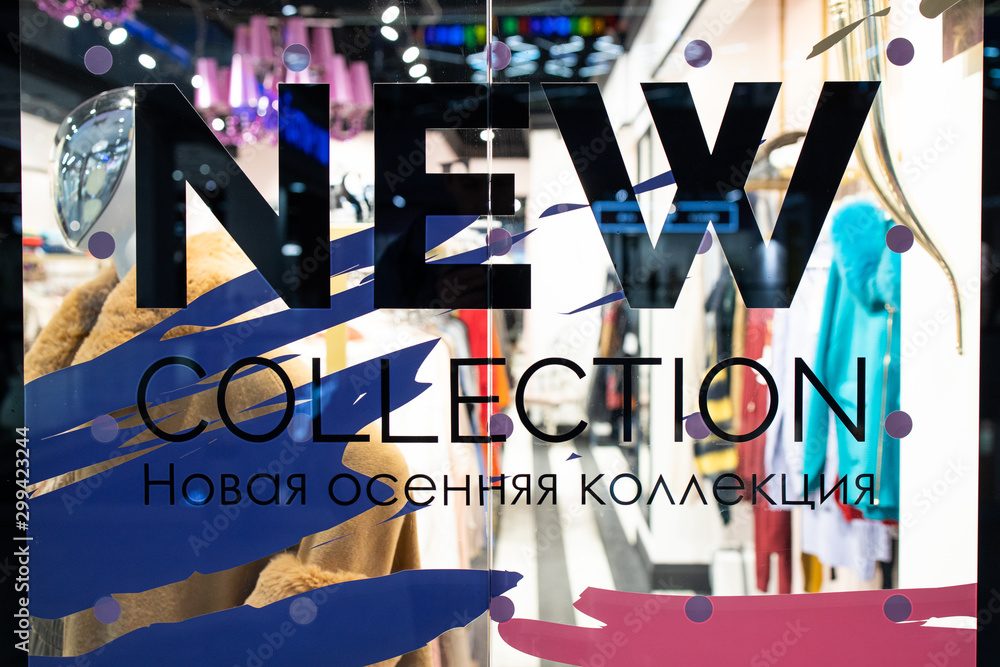 New collection sign in a shop window. New season in retail. Retail ...