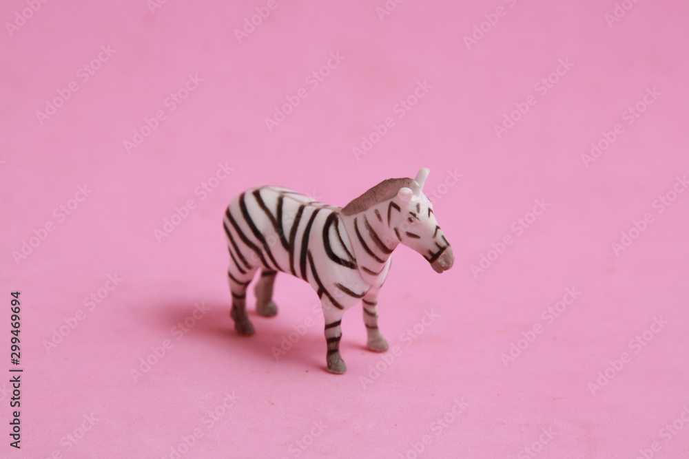 plastic toy with zebra shape in color background Stock Photo | Adobe Stock