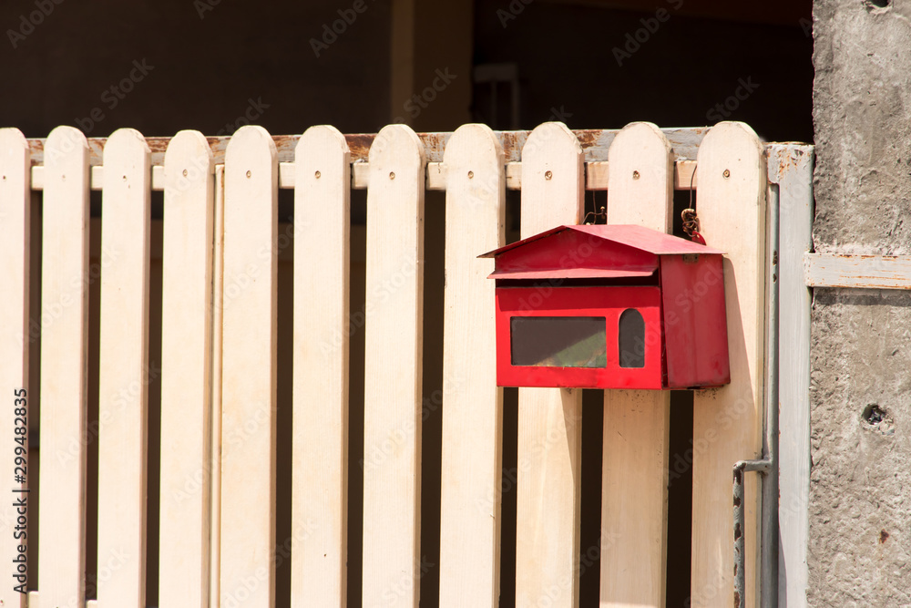 Mailbox in front of the house and gate with sunlight and beautiful ...