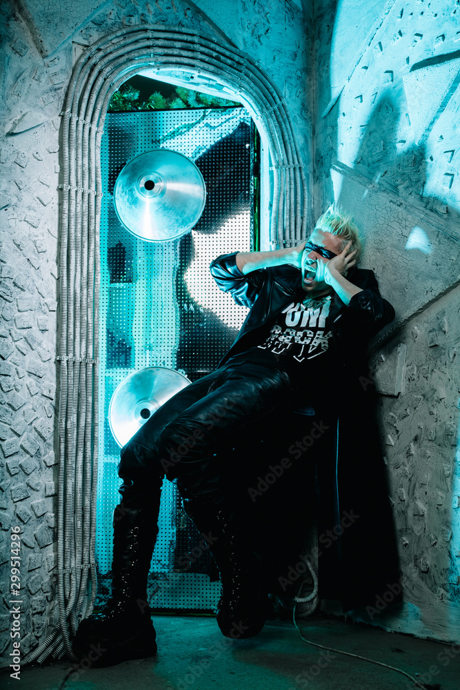 Fashion portrait of the young beautiful alternative man in leather long ...