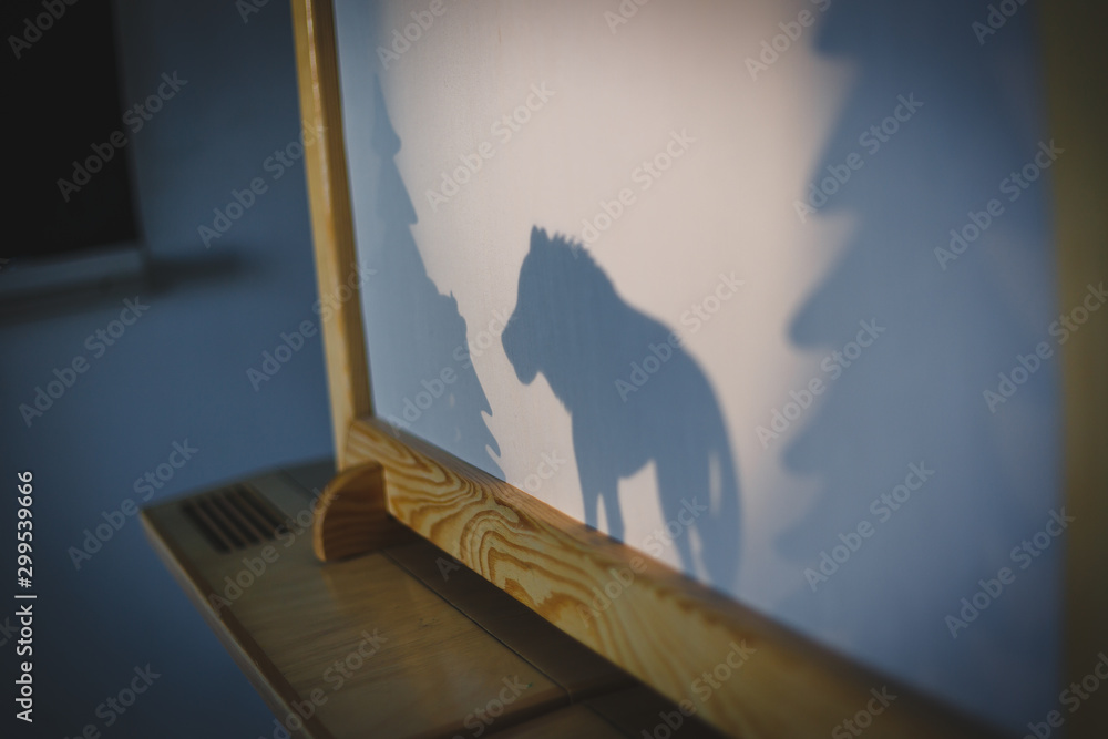 teacher do a shadow play wolf in kindergarten or preschool. child play ...