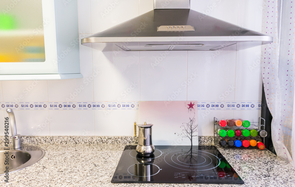 ceramic hob with coffee maker and extractor hood Stock Photo | Adobe Stock