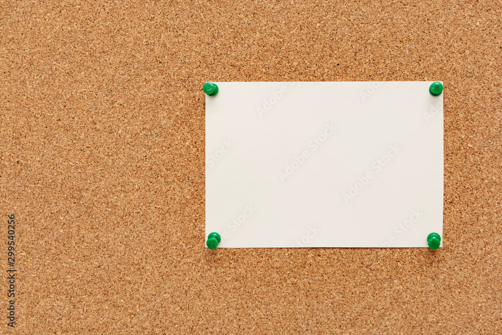 Note paper swith push pins on cork board. Empty paper pages for notes ...