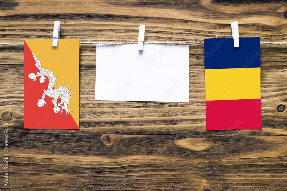 Hanging flags of Bhutan and Chad attached to rope with clothes pins ...