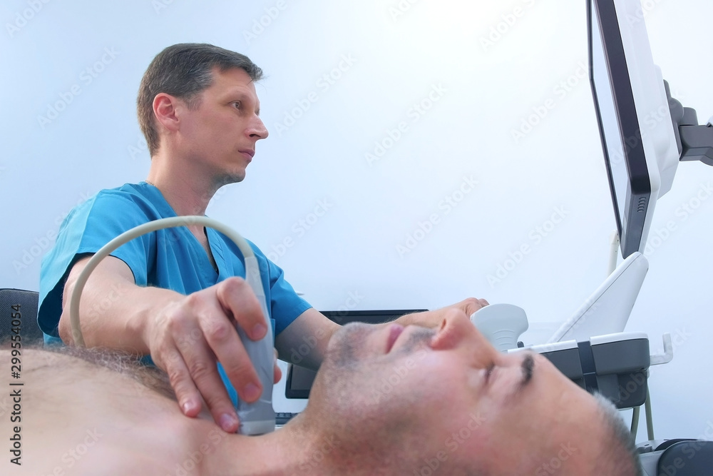 Scanning of thyroid gland at ultrasound sanner device machine in ...