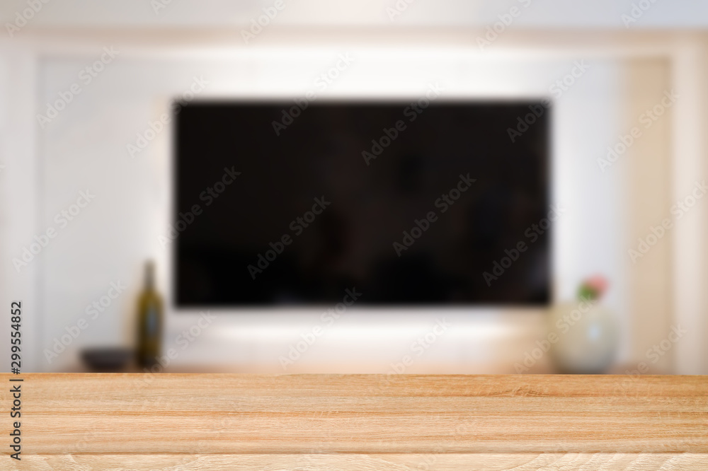 empty wooden table top with tv in living room blurred background. Stock ...