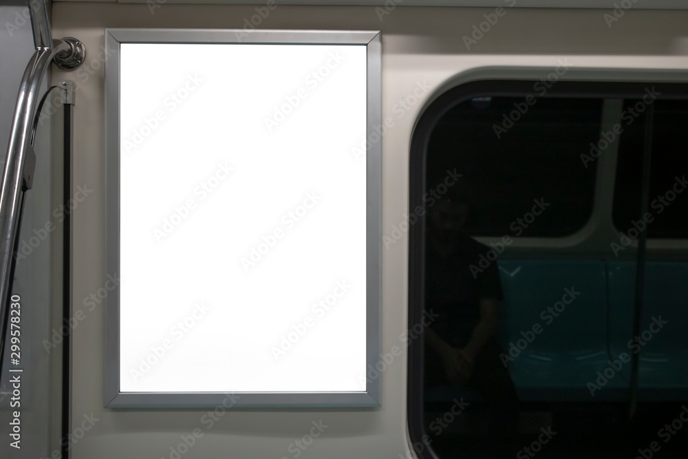 Blank advertising sign inside subway train. Close to the glass edge of ...