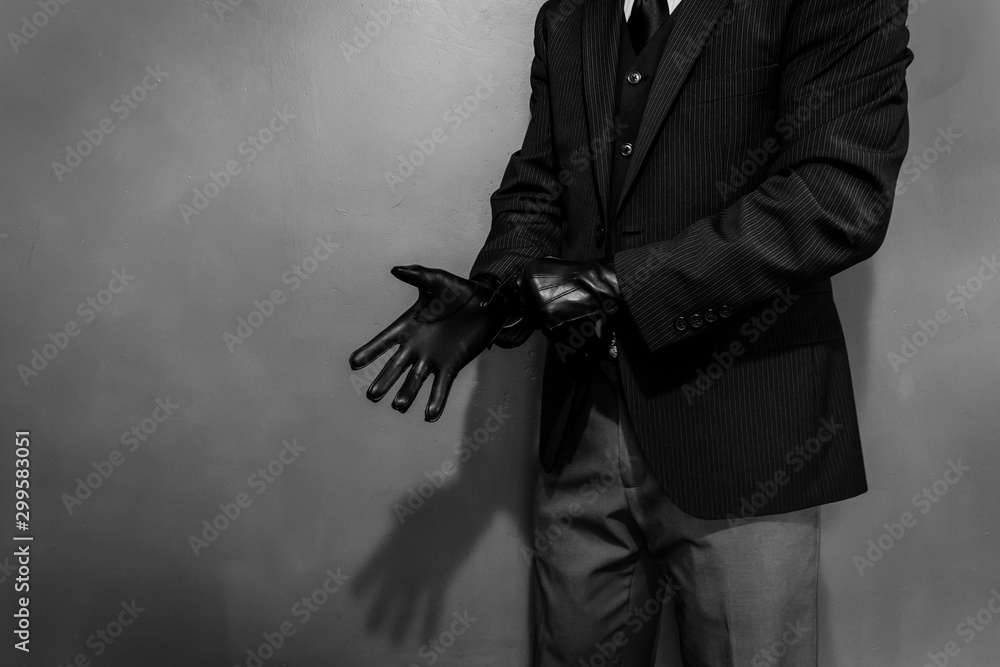 Black and White Portrait of Man in Dark Suit Pulling on Leather Gloves ...