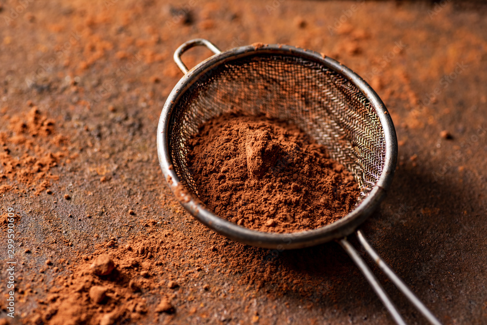 Cocoa powder in sifter on brown, metal background. Stock Photo | Adobe ...