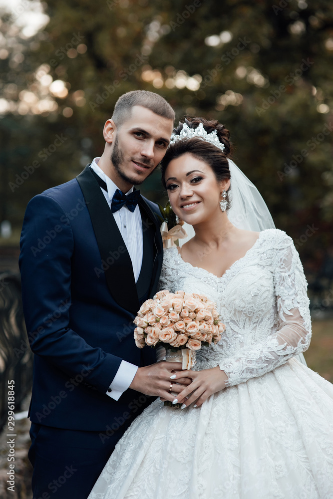 Married couple embracing in the autumn park. Amazing smiling wedding ...